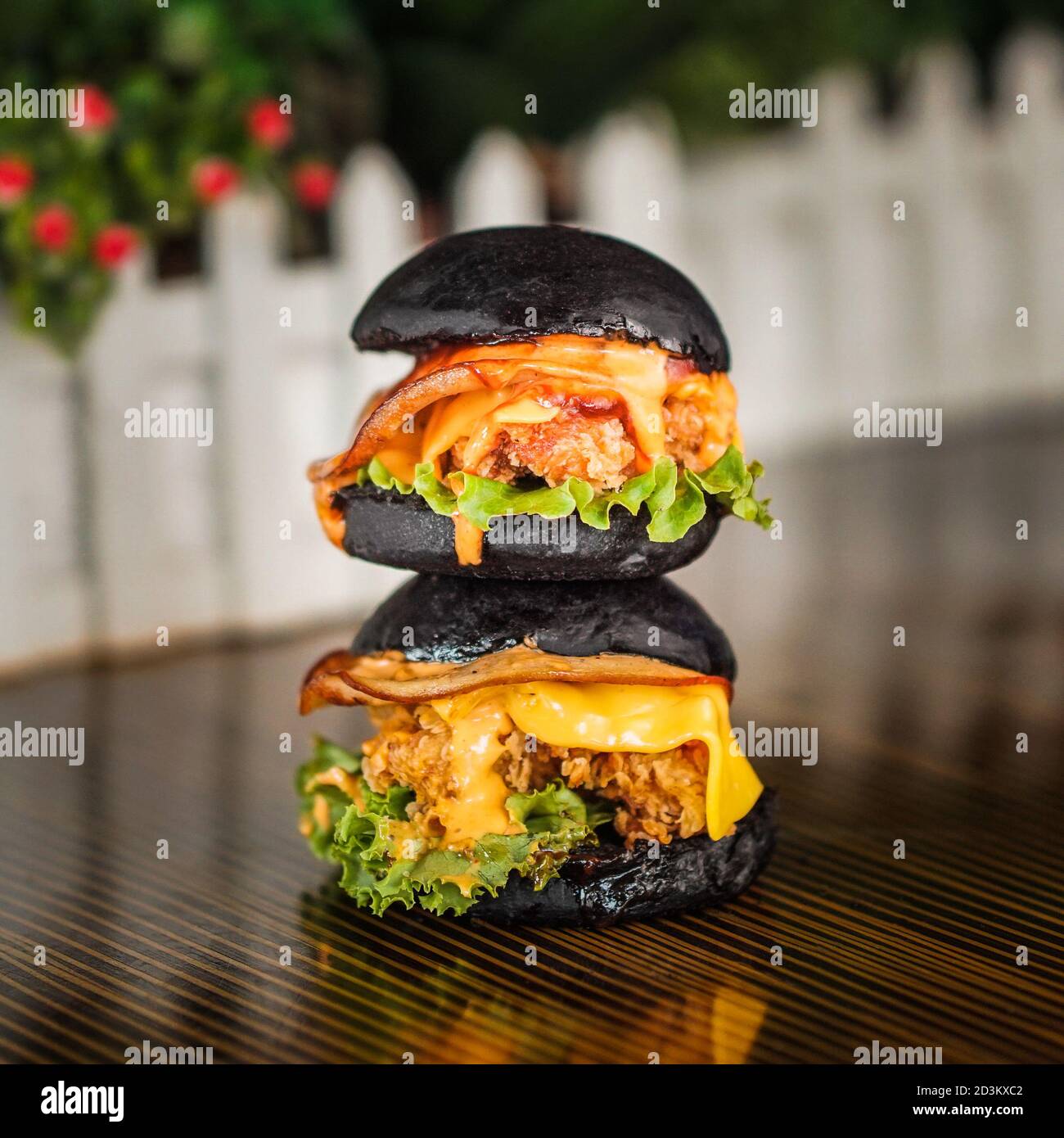 2 black burger sliders on top of one another Stock Photo - Alamy