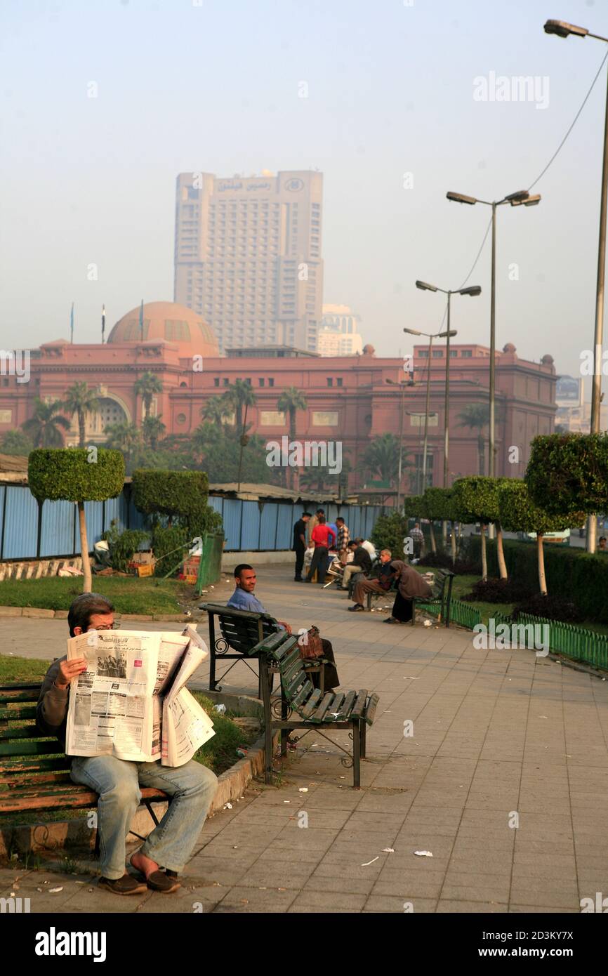Street view in Cairo. People sitting on benches in a park on the banks ...