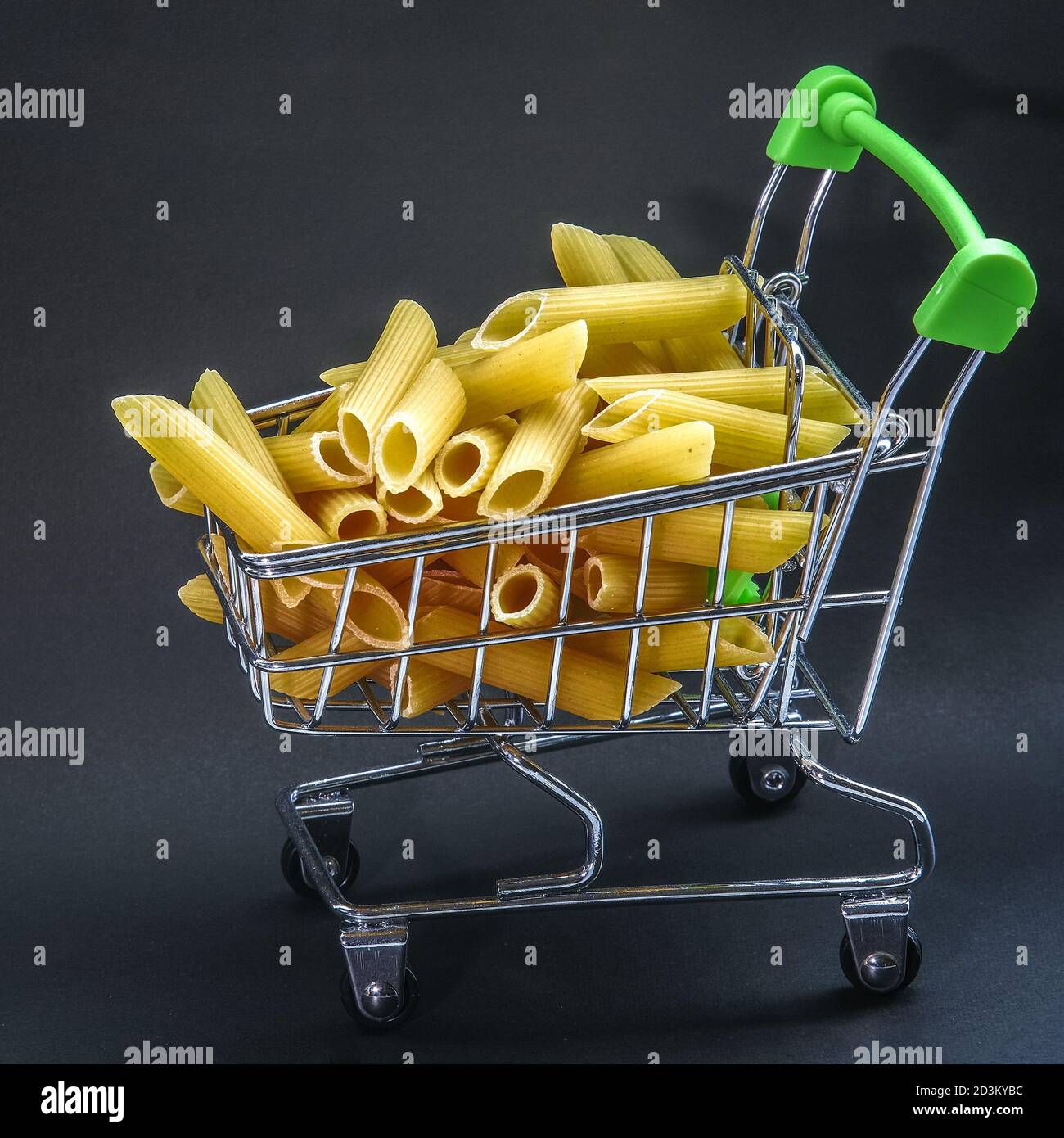 Pasta in the shape of sliced tubes, a mini supermarket cart filled to ...