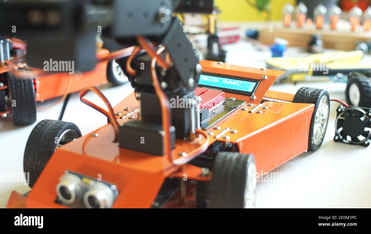 Crop teenager playing with modern robot in class Stock Photo - Alamy