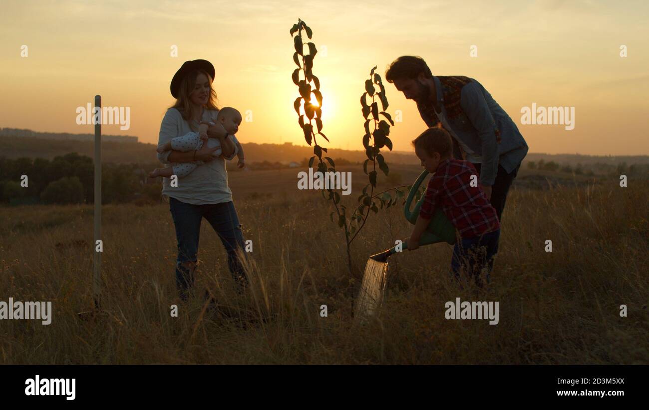 Father son planting tree together hi-res stock photography and images ...