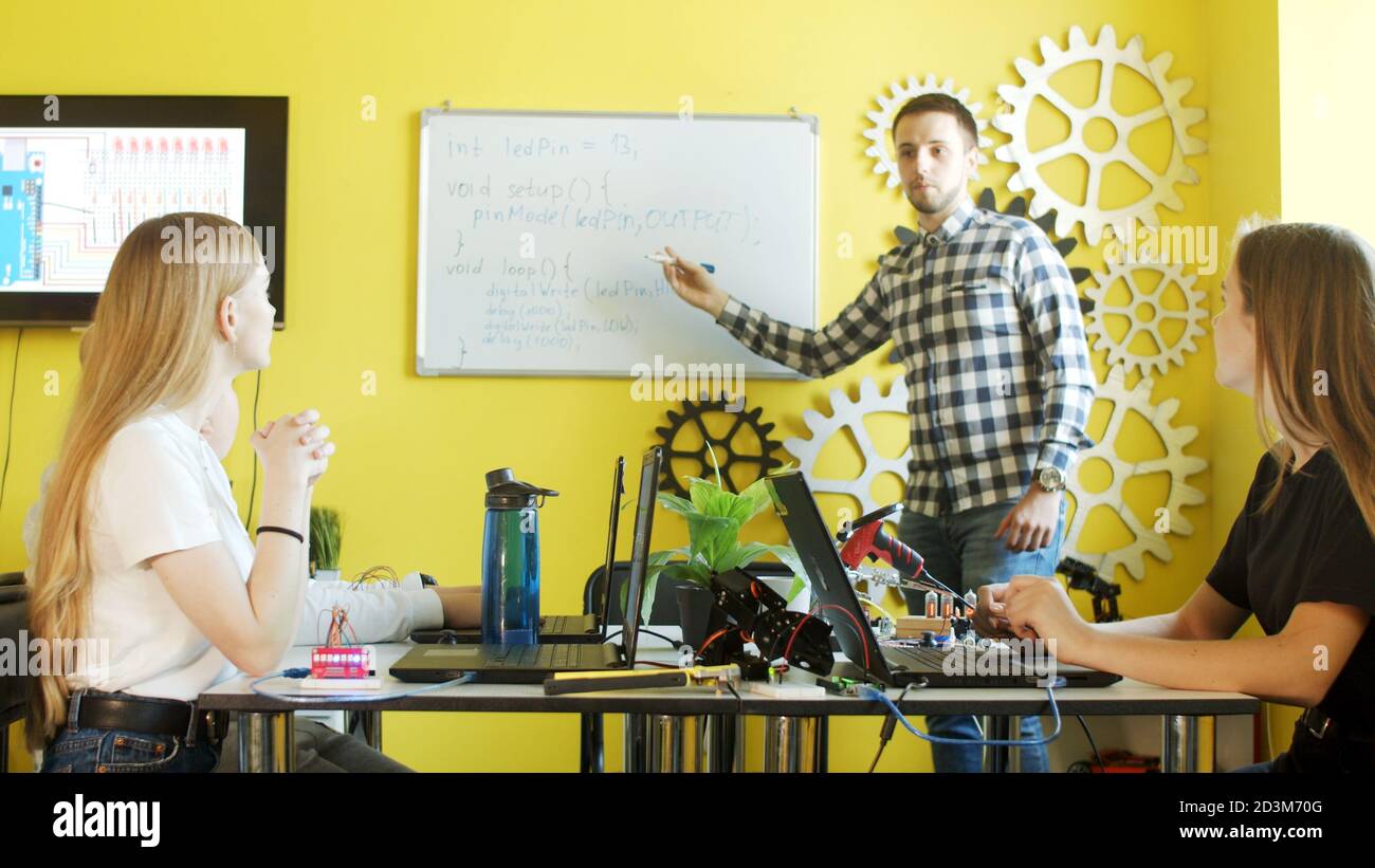 Group of students working together in classroom with laptops Stock ...