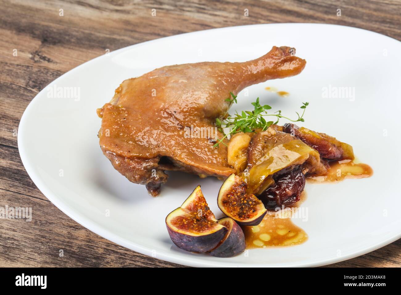 Roasted. duck. leg with plum, fig and apple Stock Photo - Alamy