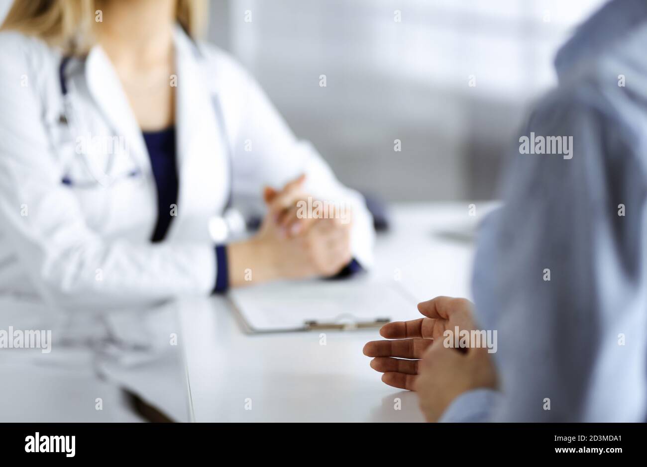 Unknown woman-doctor is prescribing some antibiotics for her patient ...