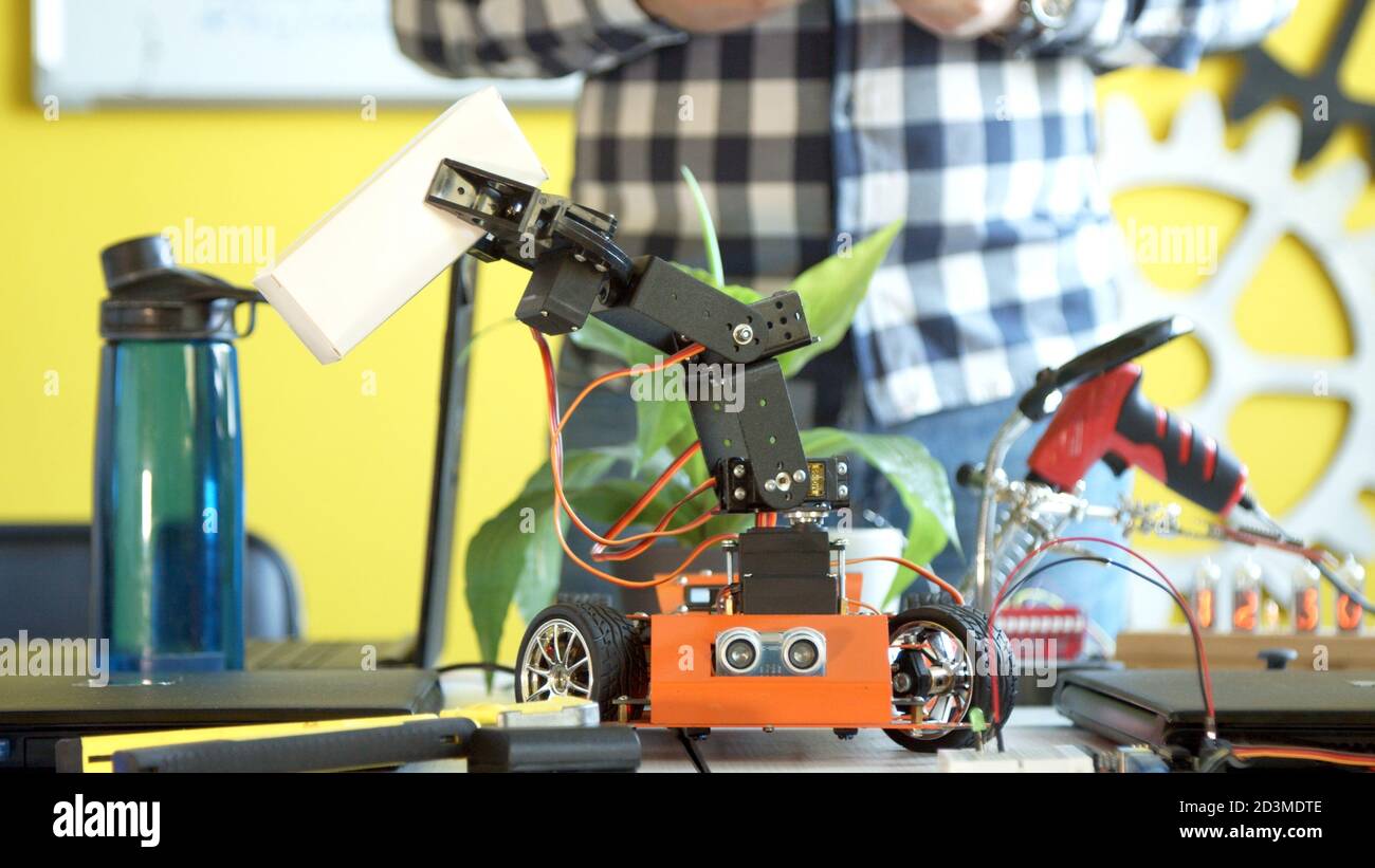 Crop teenager playing with modern robot in class Stock Photo - Alamy