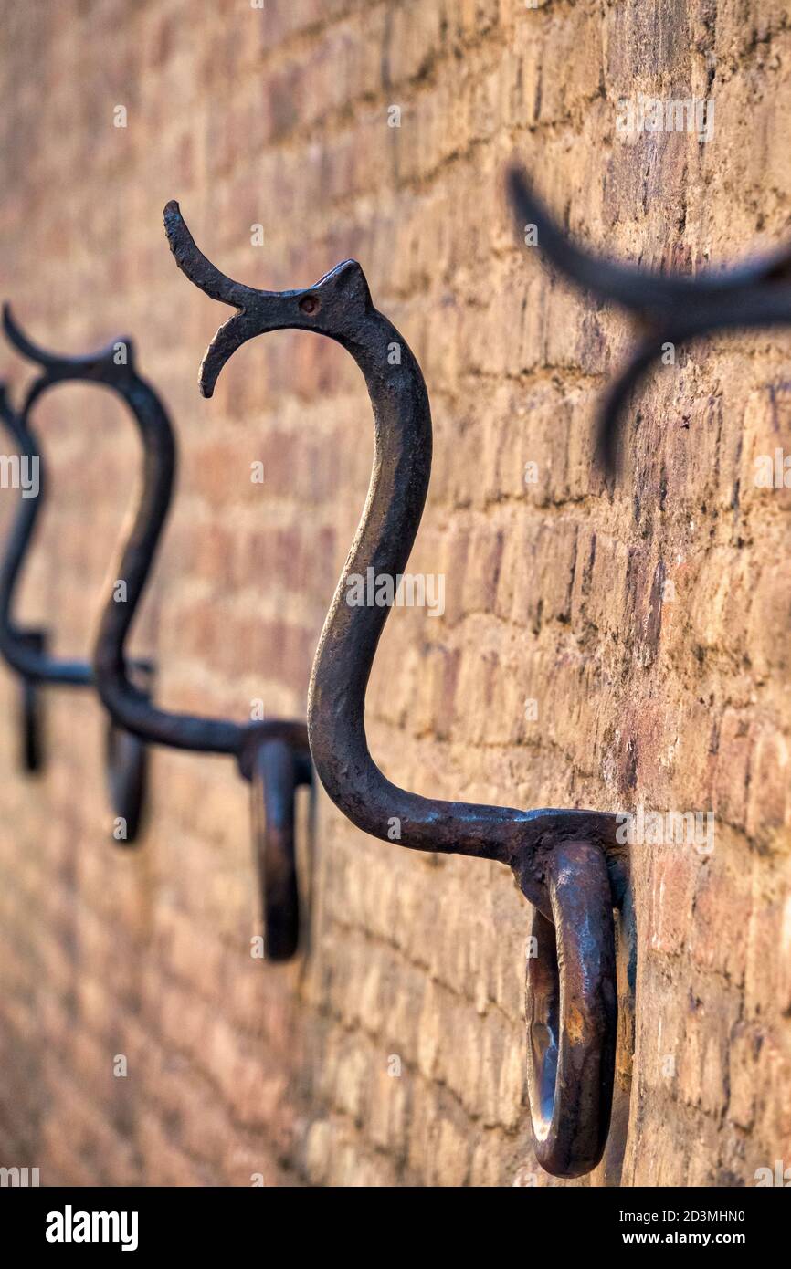 Medieval wrought iron rings used to tie horses and boats on the side of ...