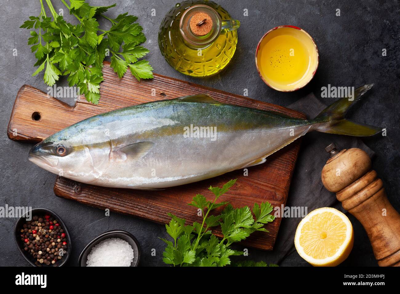 Raw fish cooking. Seafood and ingredients for dinner on stone table ...
