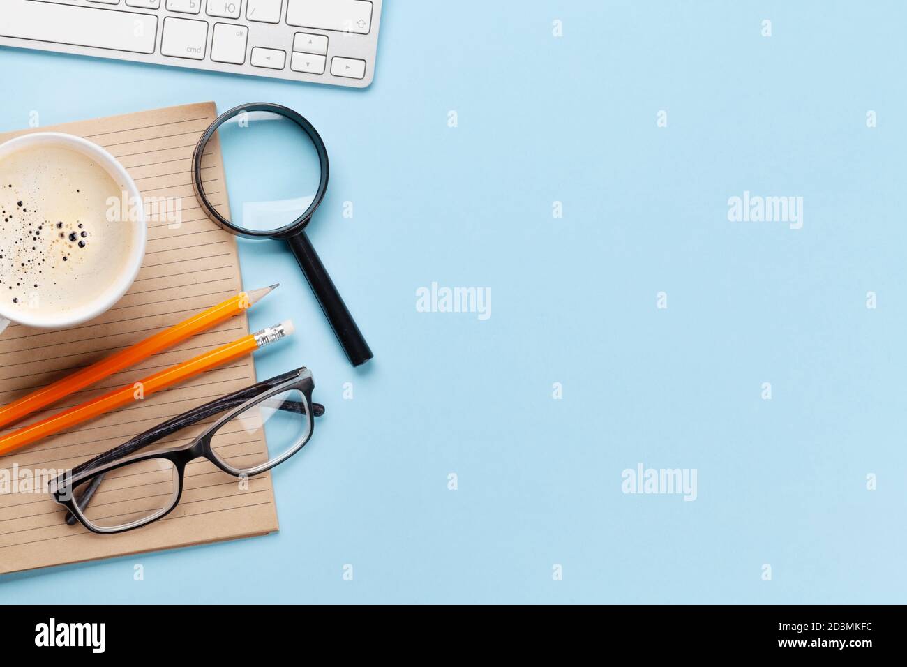 Business desk workplace and office objects over blue backdrop. Top view ...