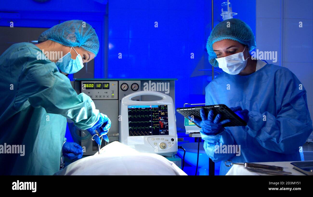 Female medics performing surgery in hi-res stock photography and images ...