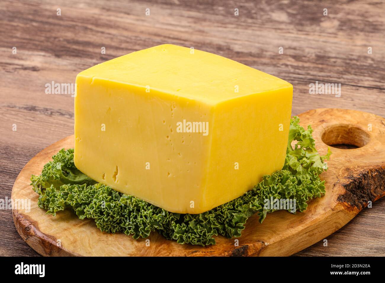 Yellow tilsiter cheese dairy product brick Stock Photo - Alamy