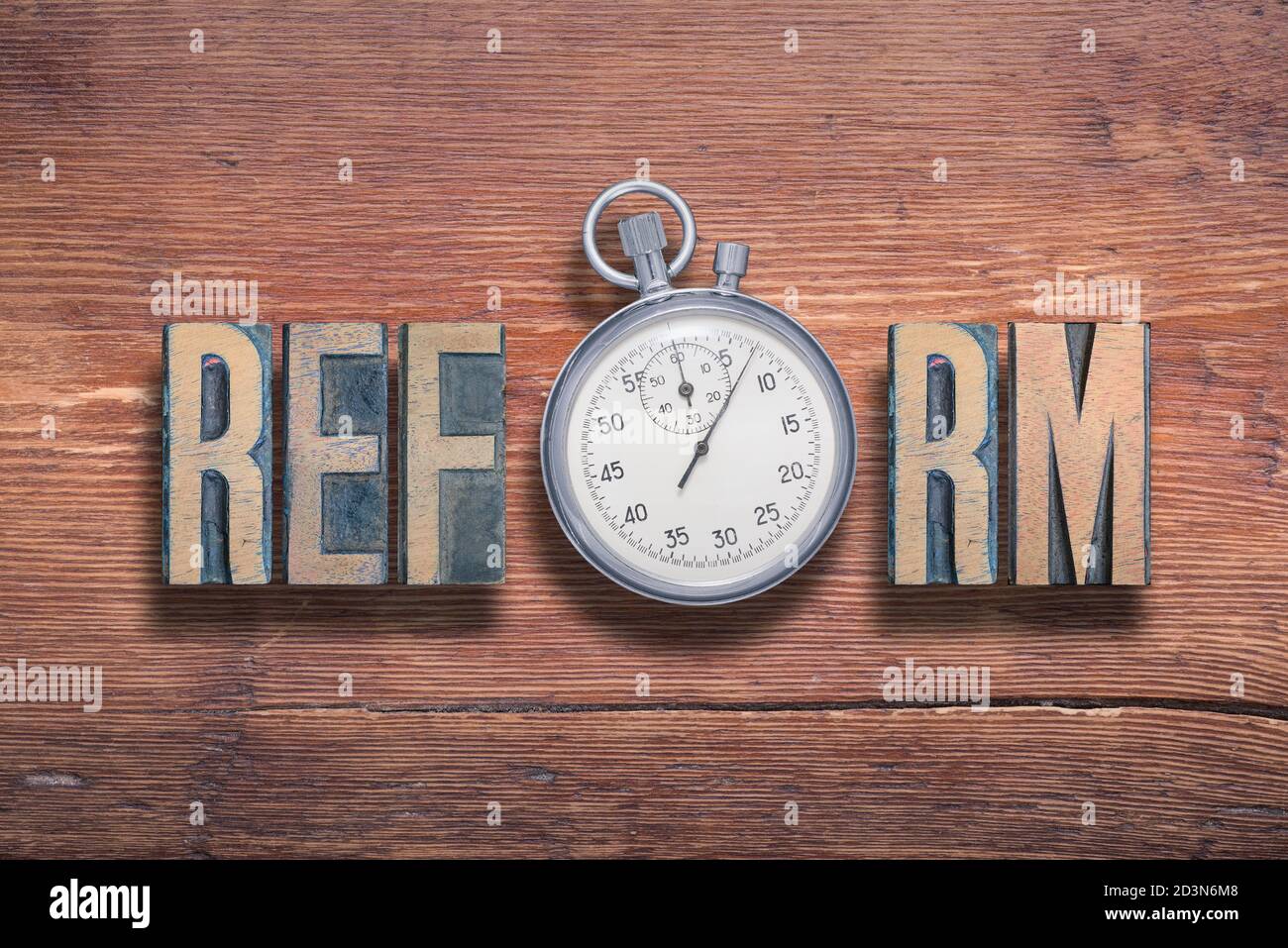 reform word combined on vintage varnished wooden surface with stopwatch ...