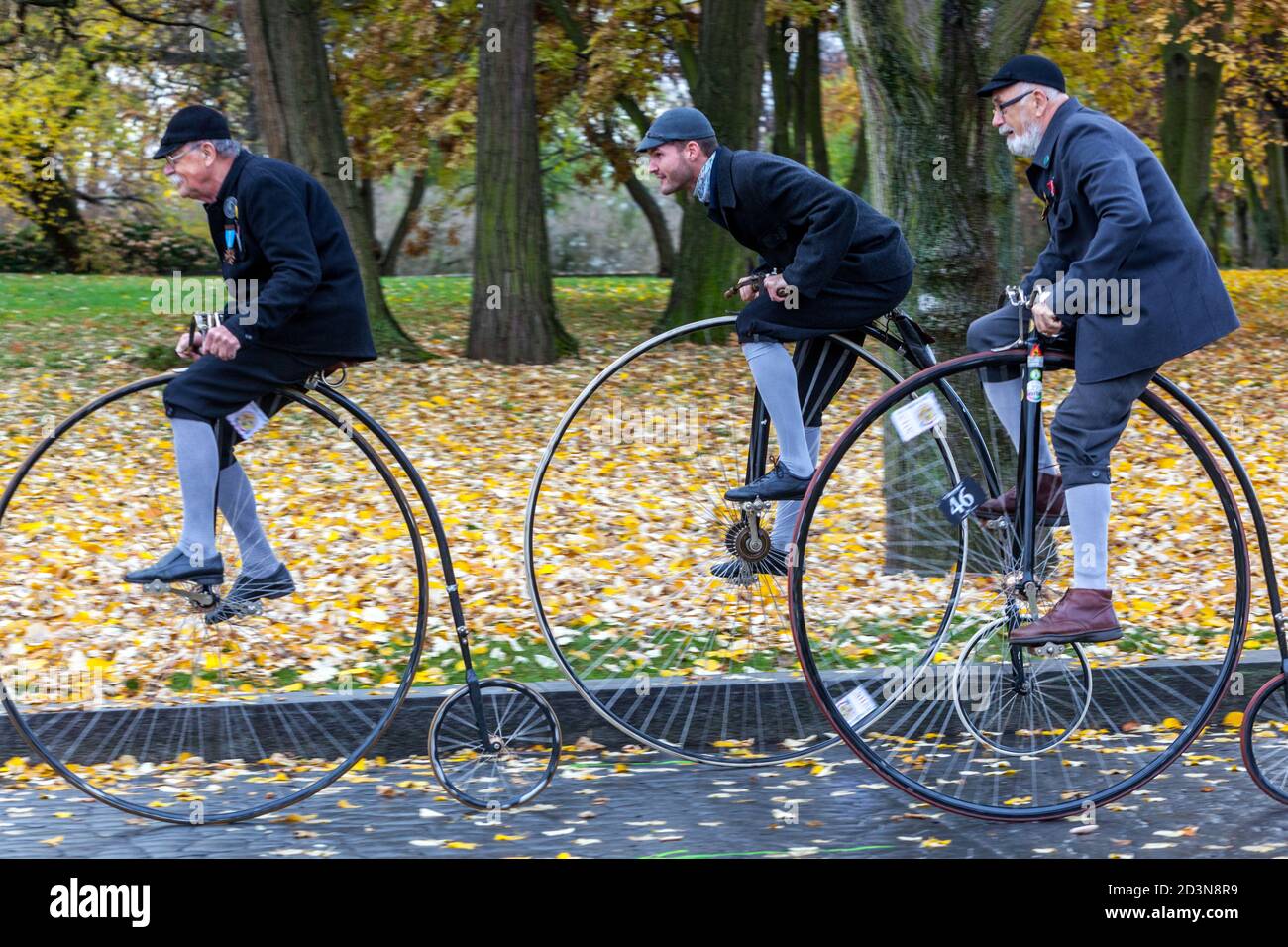 Three cyclists on Penny Farthing bicycle cycle race Stock Photo - Alamy