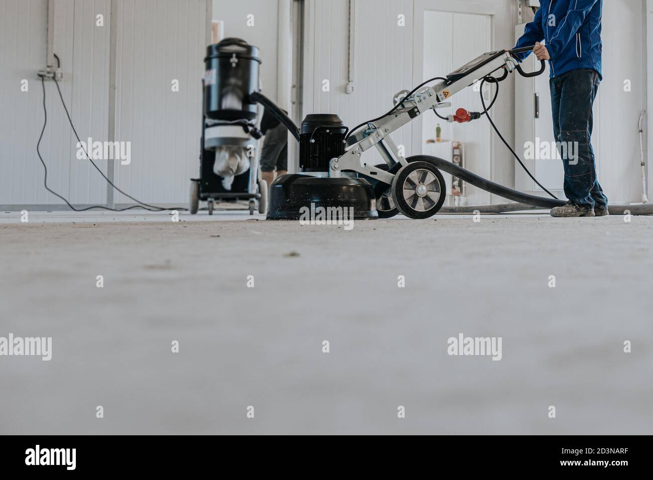 Construction Worker Using Machine Polishing Surface Floor Smoothing And