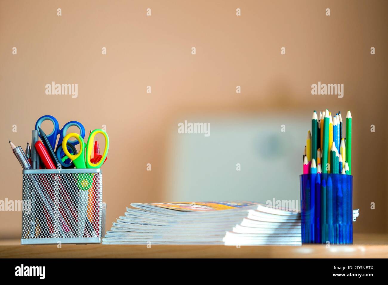 Stack of notebooks, colorful drawing pencils and stationery arrangement ...