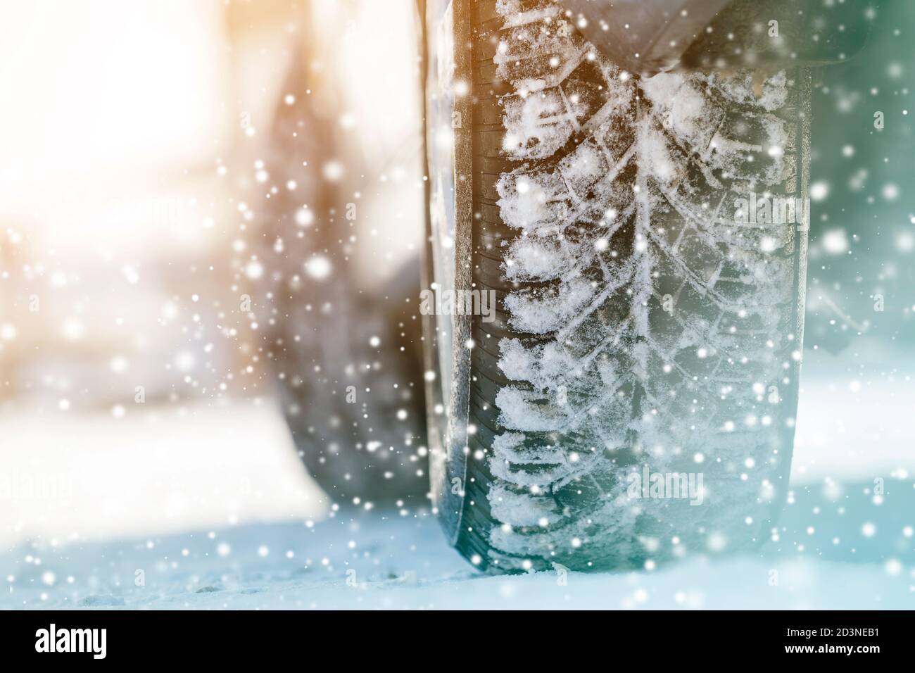 Close-up of car wheels rubber tires in deep winter snow. Transportation ...