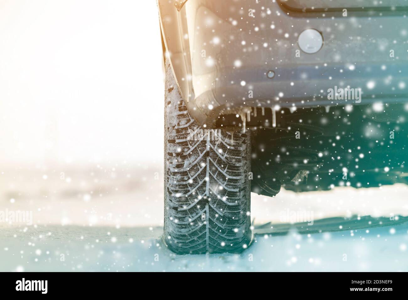 Close-up of car wheels rubber tires in deep winter snow. Transportation ...