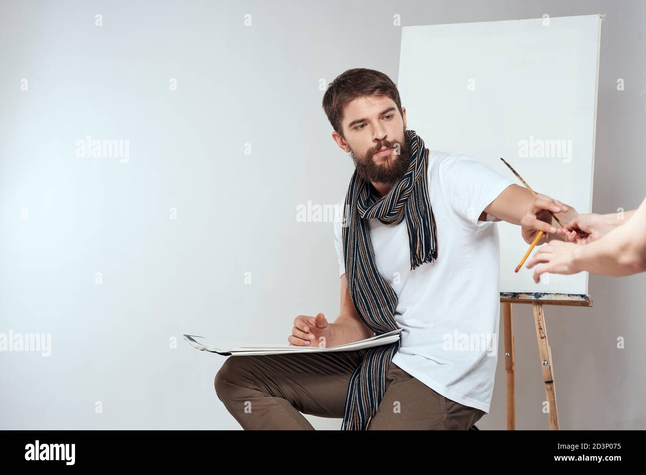 Male artist sitting on chair drawing brush easel hobby Creative light ...