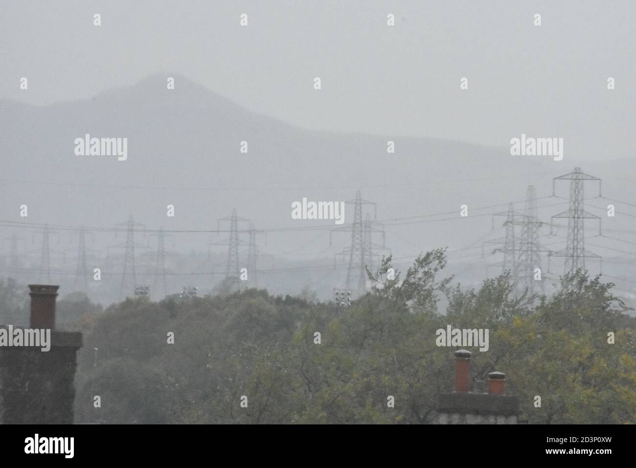 Skyline with pylons and hills in background Stock Photo - Alamy