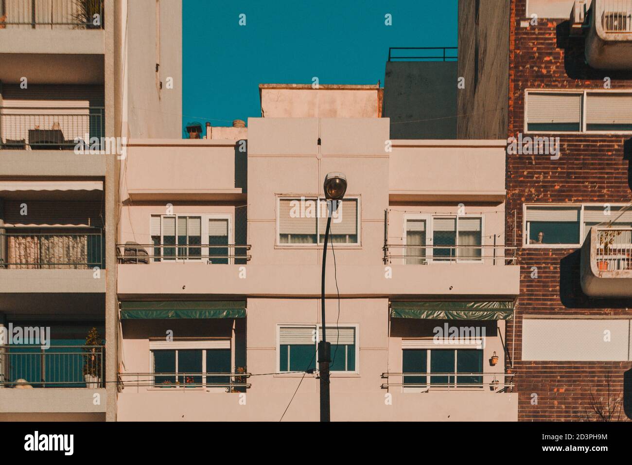 Small building between two tall buildings Stock Photo - Alamy