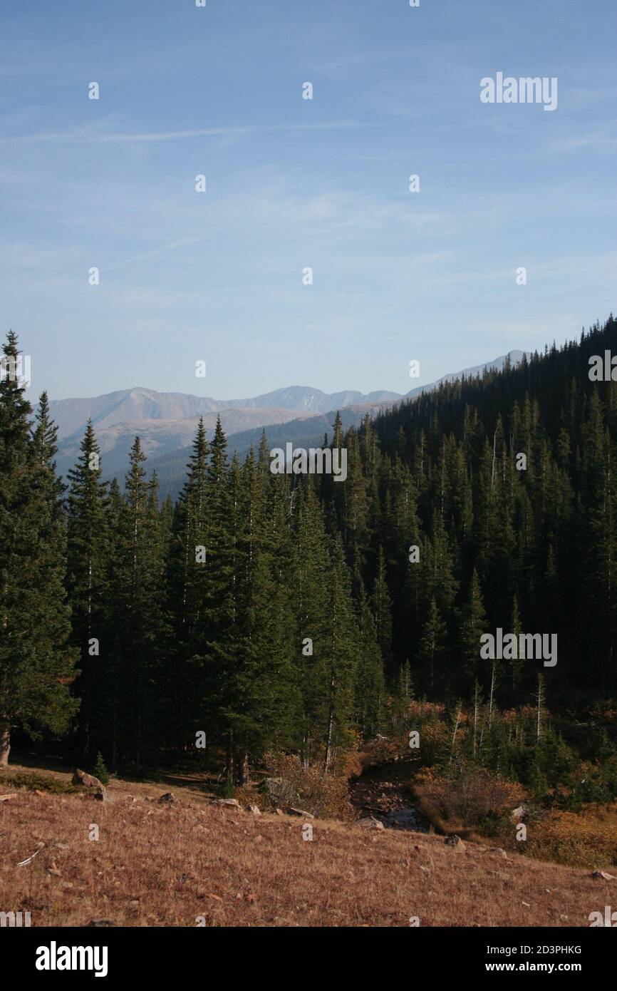 Herman Gulch, CO, shrouded by wildfire smoke over the autumn grass and ...
