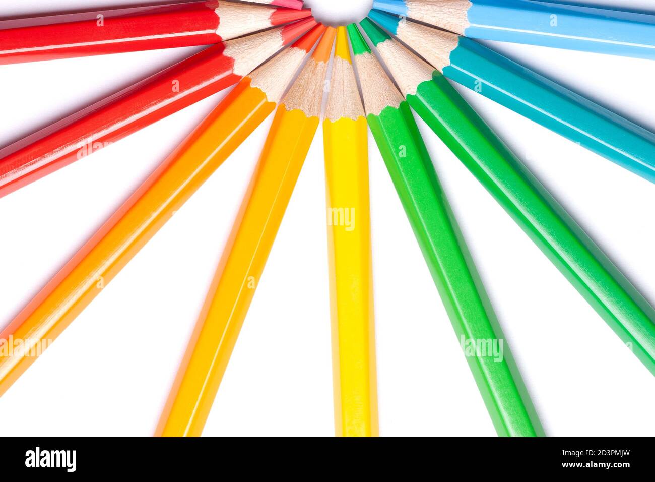 circle or semicircle of colored sharp pencils spouts in the center on a ...