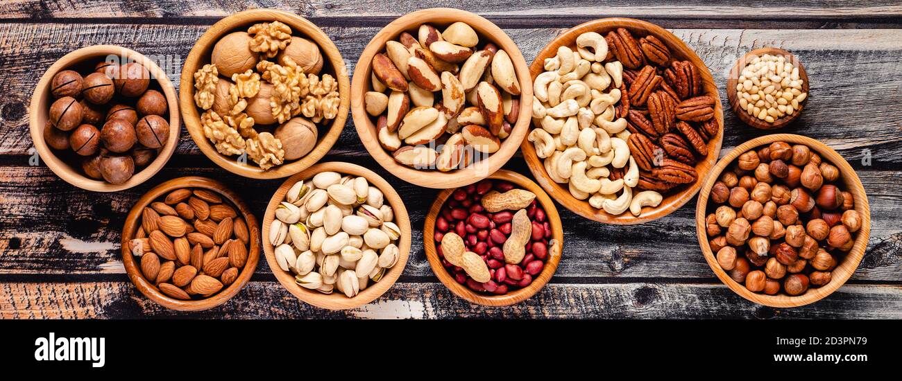 Various Nuts in wooden bowls, top view Stock Photo - Alamy