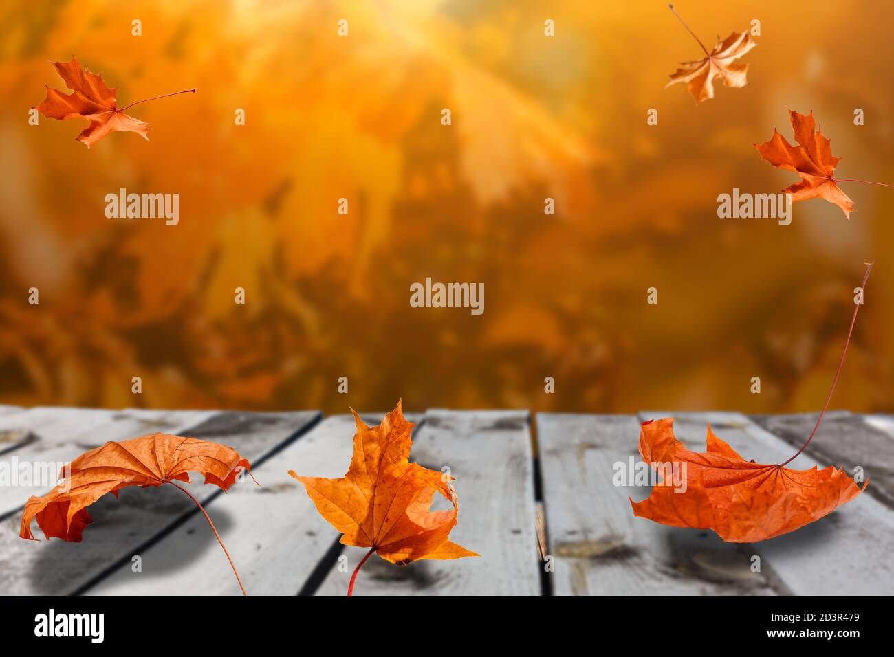Wooden table with orange leaves autumn background Stock Photo - Alamy