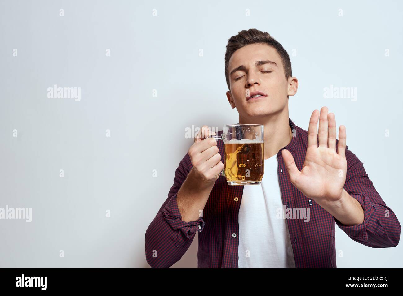Drunk man with a mug of beer vacation alcohol lifestyle in a red shirt ...