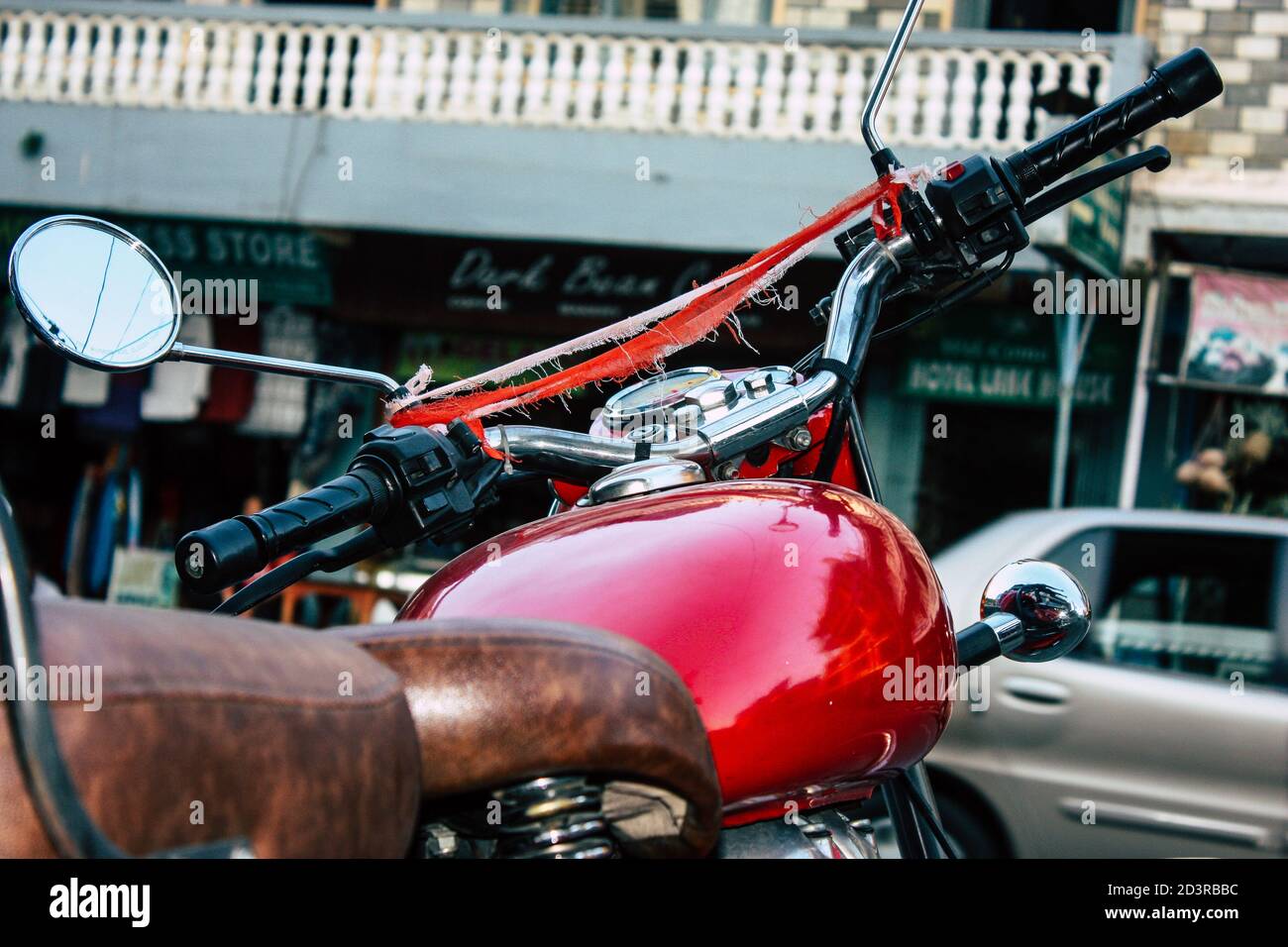 Closeup of a motorcycle rolling in the streets of the city center of ...