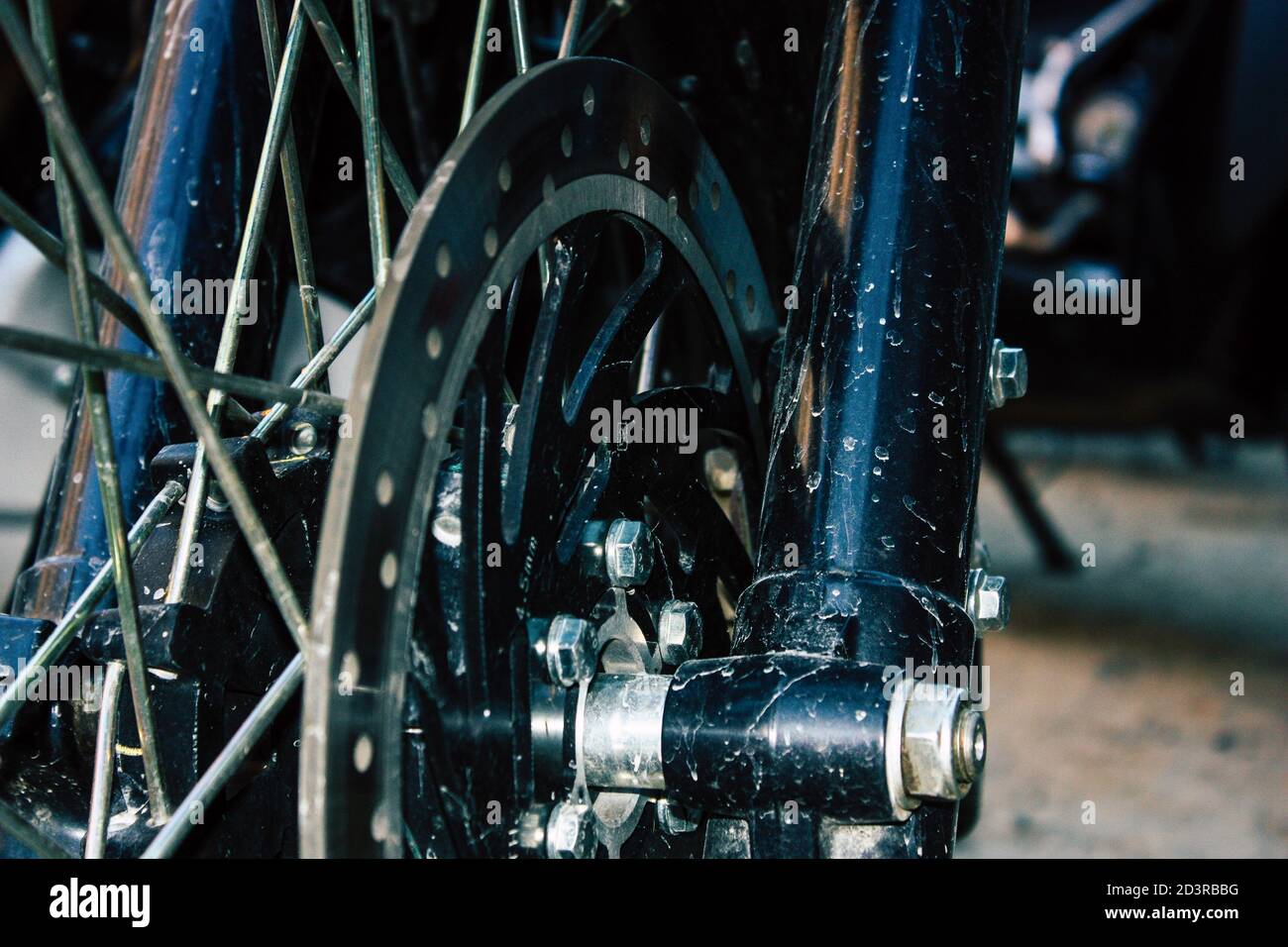 Closeup of a motorcycle rolling in the streets of the city center of ...