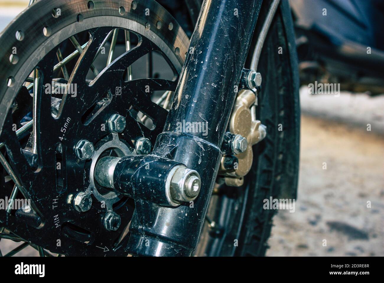 Closeup of a motorcycle rolling in the streets of the city center of ...