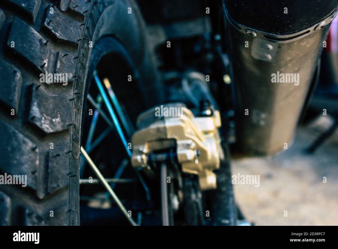 Closeup of a motorcycle rolling in the streets of the city center of ...
