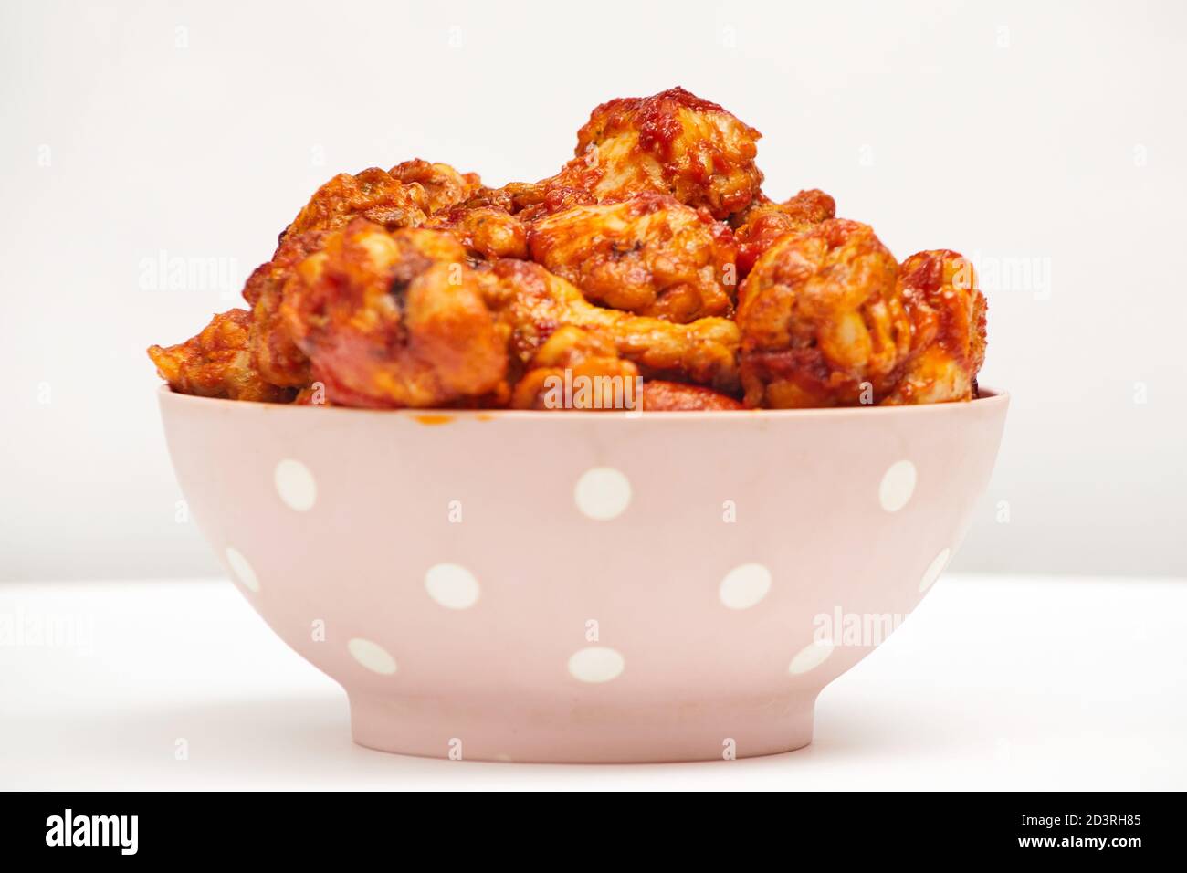 Buffalo chicken wings in a plate on a white background, copy space ...
