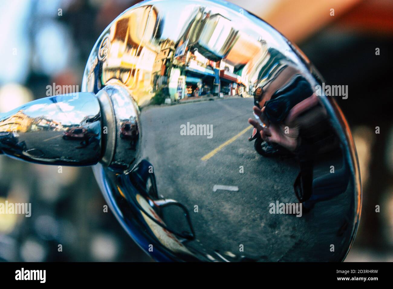 Closeup of a motorcycle rolling in the streets of the city center of ...