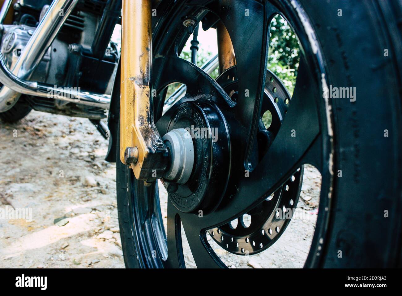 Closeup of a motorcycle rolling in the streets of the city center of ...