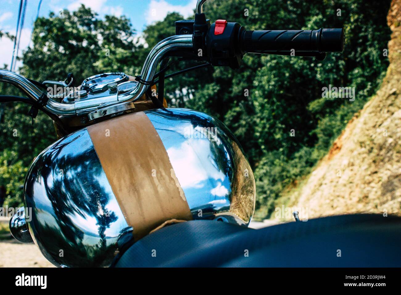 Closeup of a motorcycle rolling in the streets of the city center of ...