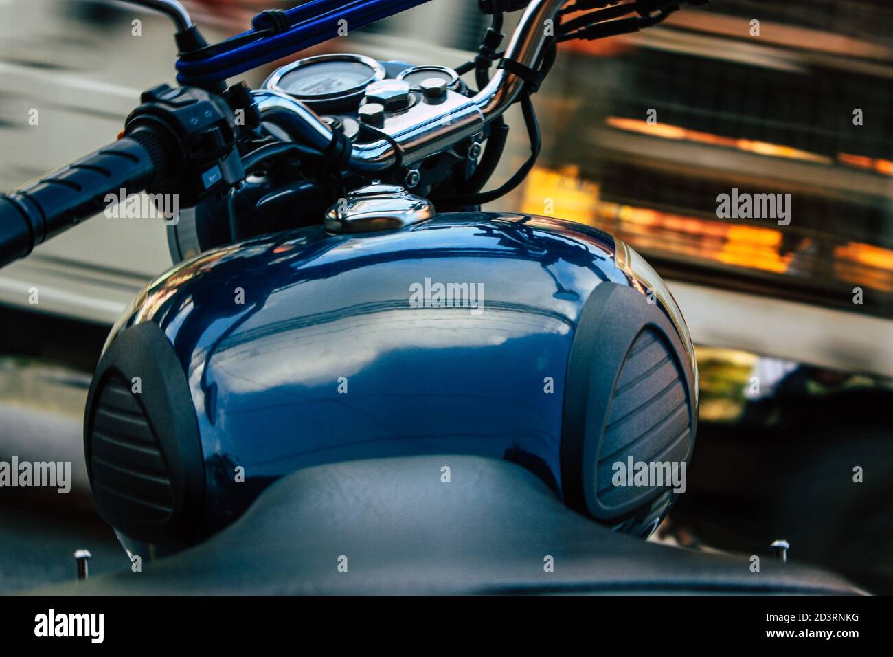 Closeup of a motorcycle rolling in the streets of the city center of ...