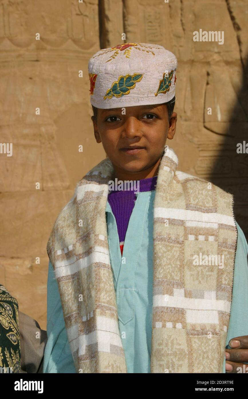 An arabic boy by the wall in Edfu, Temple of Horus in the Nile Valley ...