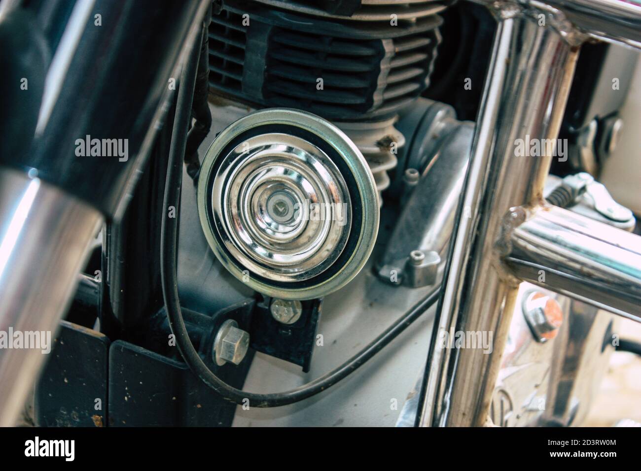 Closeup of a motorcycle rolling in the streets of the city center of ...