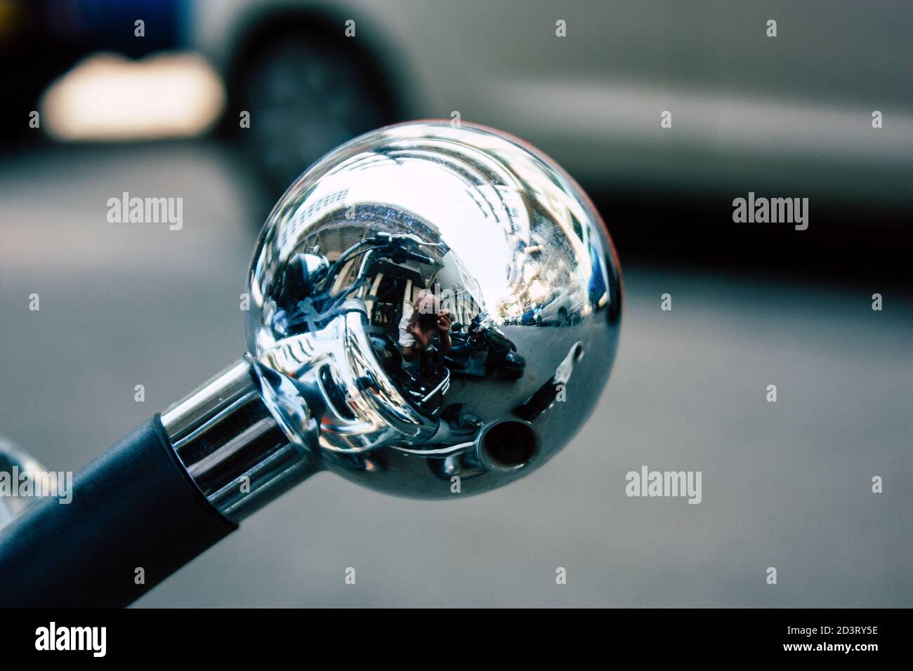 Closeup of a motorcycle rolling in the streets of the city center of ...