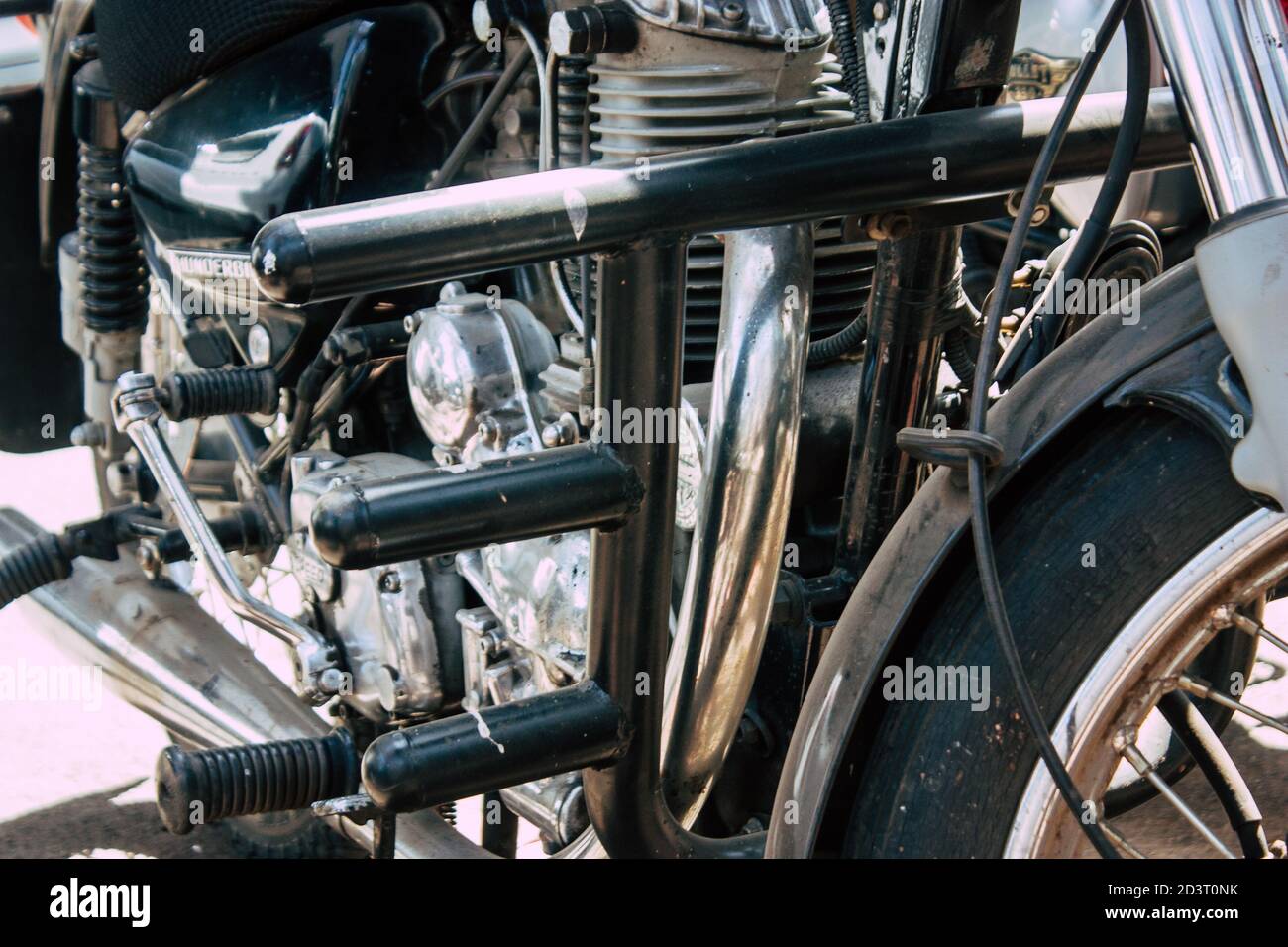 Closeup of a motorcycle rolling in the streets of the city center of ...