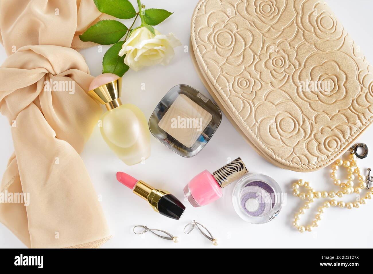 Cosmetics, perfumes, jewelry made of pearls and handbag on a white ...