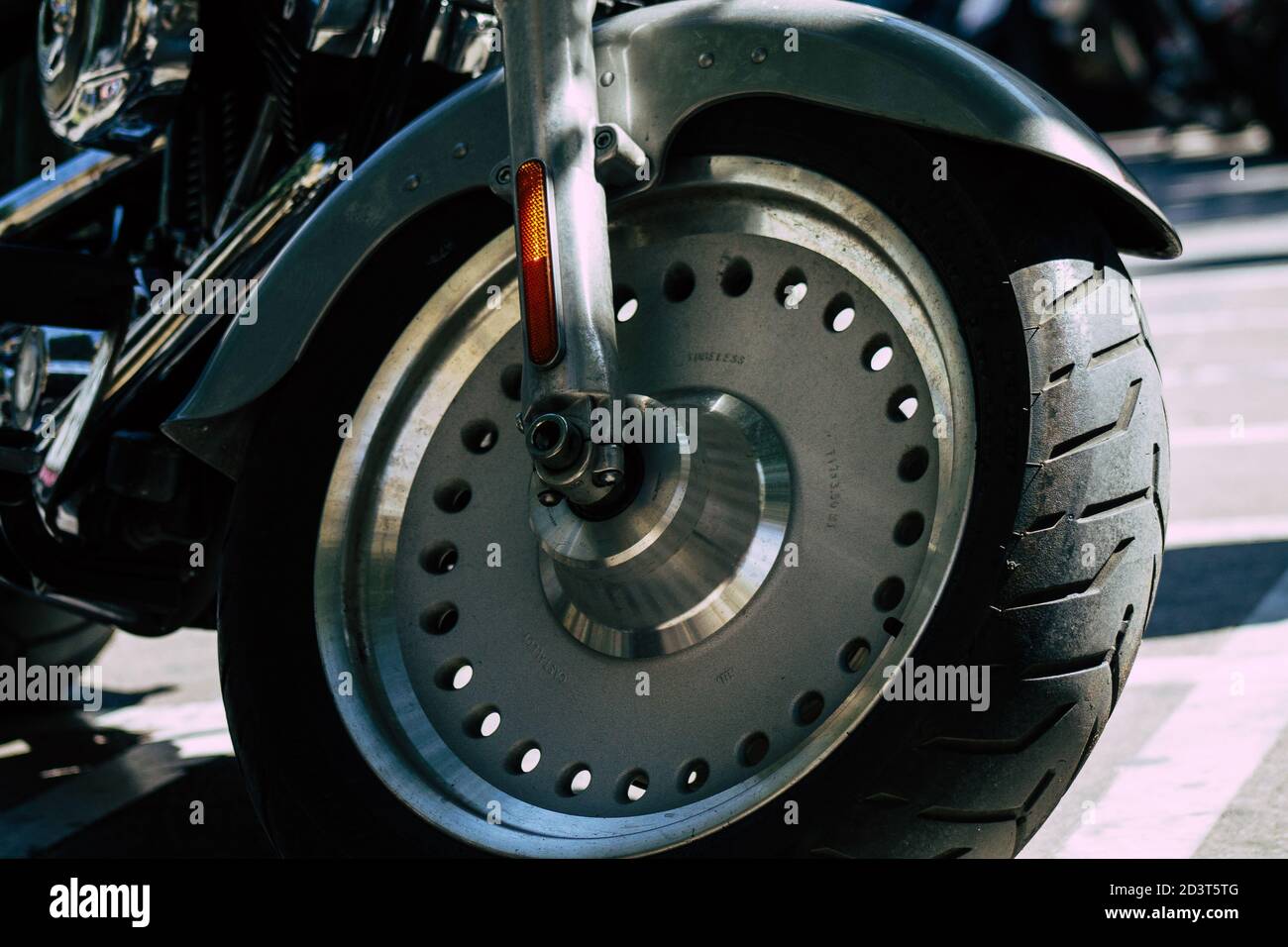Closeup of a motorcycle rolling in the streets of the city center of ...