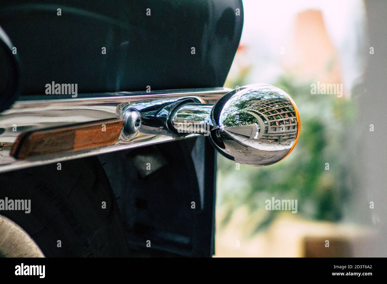 Closeup of a motorcycle rolling in the streets of the city center of ...