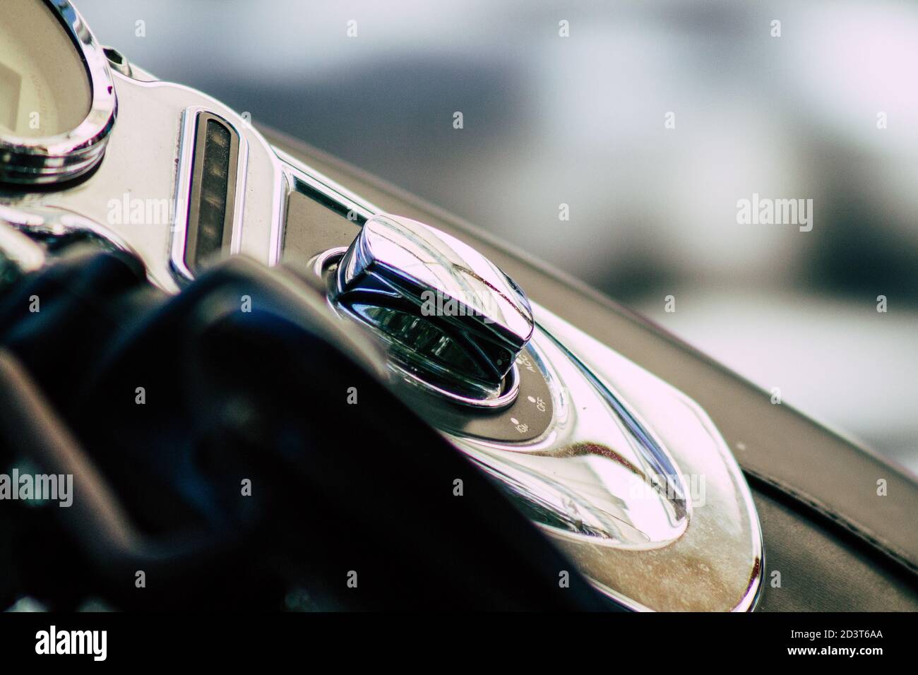 Closeup of a motorcycle rolling in the streets of the city center of ...