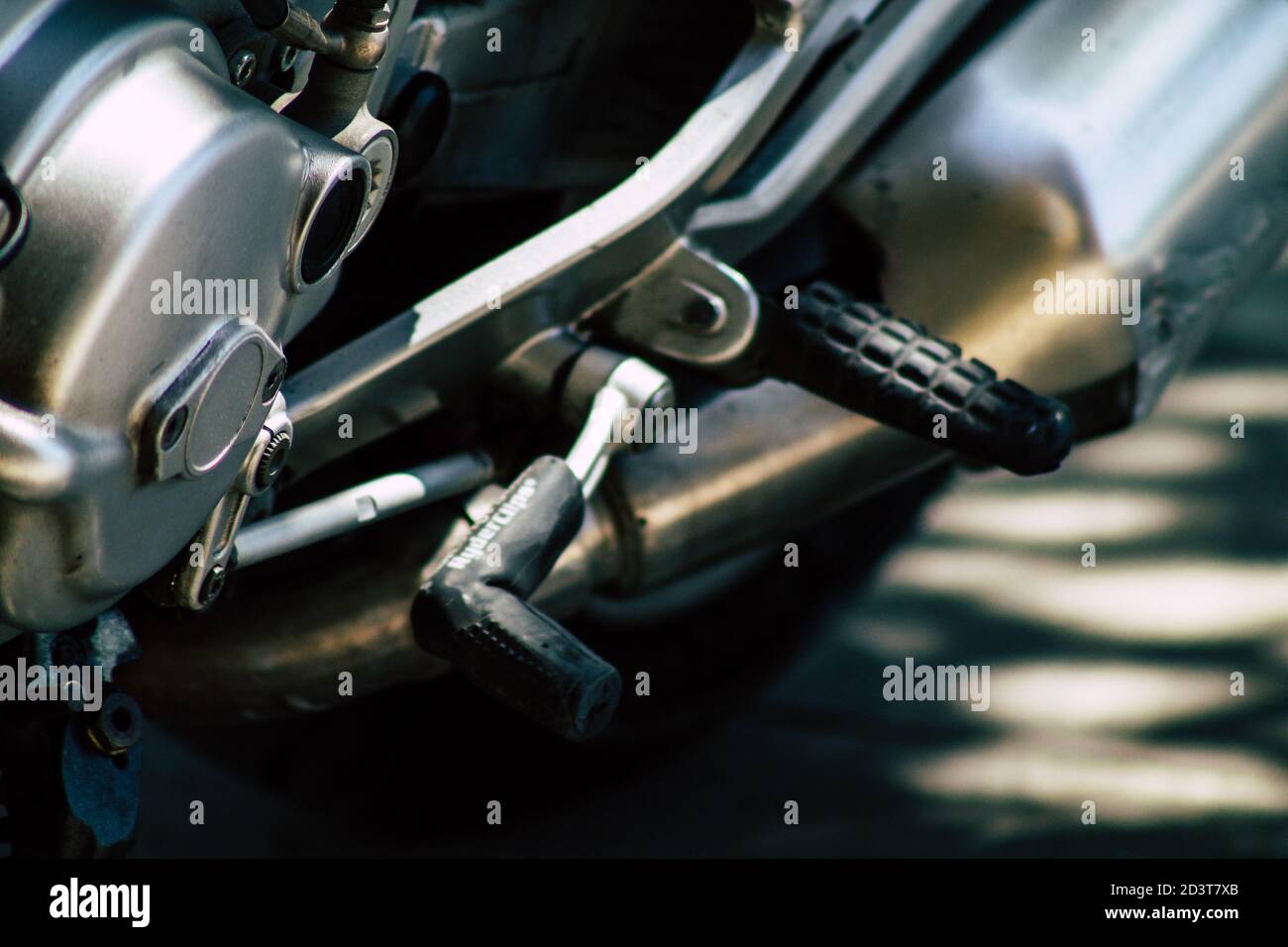 Closeup of a motorcycle rolling in the streets of the city center of ...