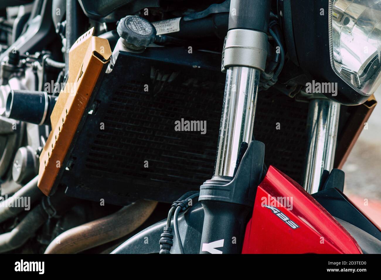 Closeup of a motorcycle rolling in the streets of the city center of ...