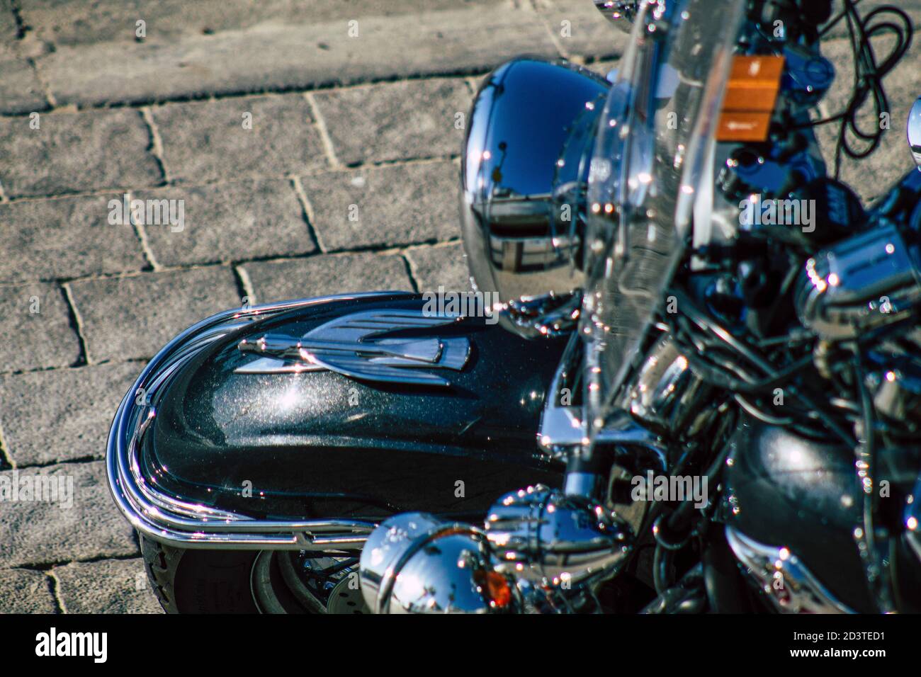 Closeup of a motorcycle rolling in the streets of the city center of ...
