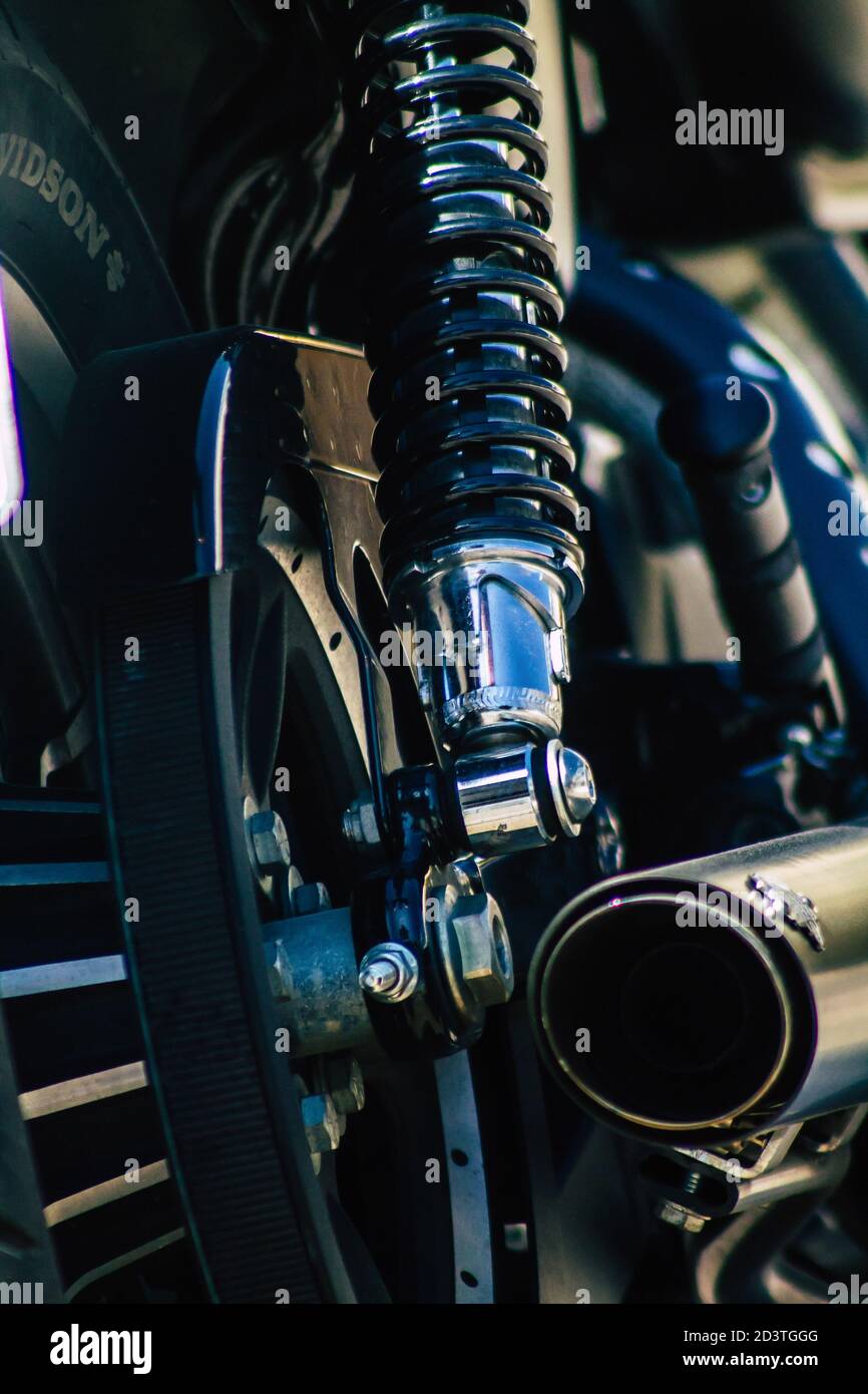 Closeup of a motorcycle rolling in the streets of the city center of ...