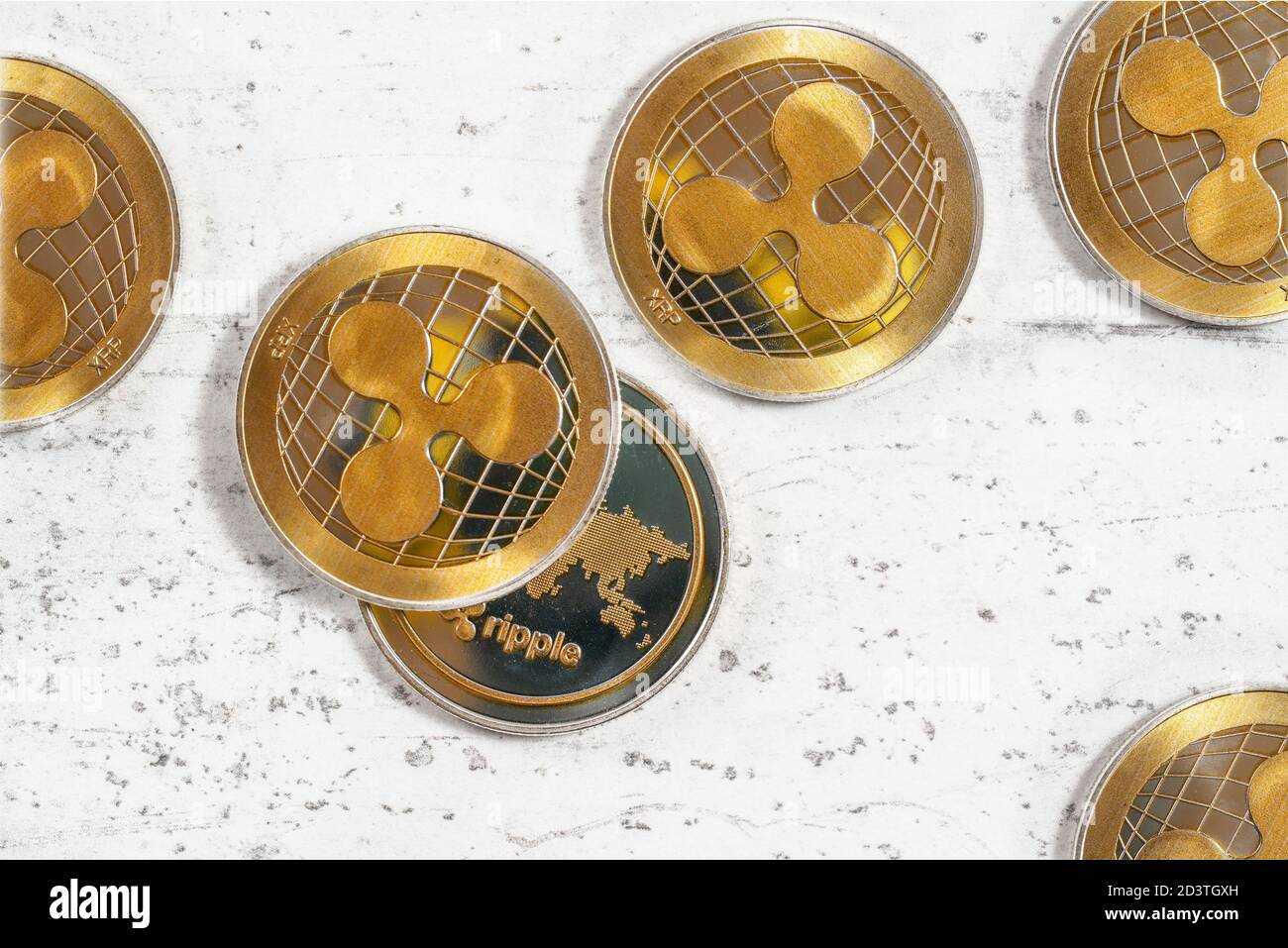 Top down view - XRP ripple cryptocurrency golden coins on white stone ...